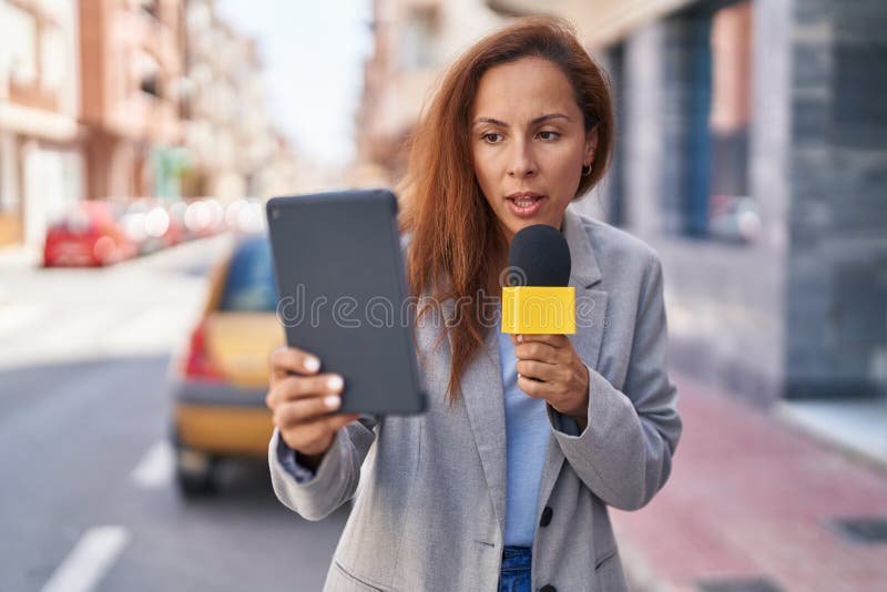 Young Woman Reporter Working Using Microphone and Touchpad at Street ... Young Woman Reporter Working Using Microphone and Touchpad at Street ...