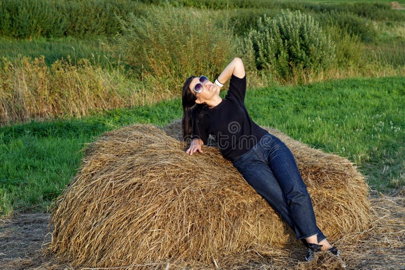 Girl on a haystack stock photo. Image of adult, golden - 209524490