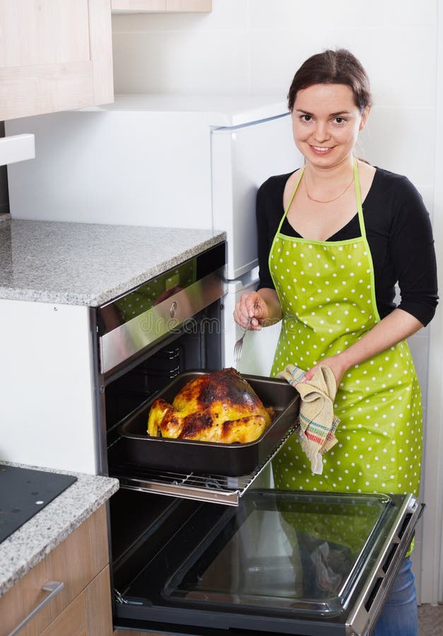 Young Woman Roasting Cockerel for Dinner Stock Photo - Image of flat ...