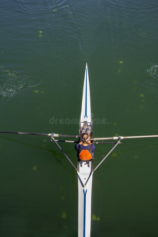 Young woman rowing in boat stock image. Image of crew - 93087771