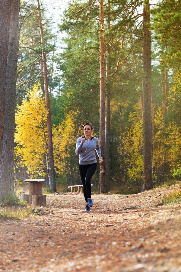 Young Woman Run in Autumn the Forest Sunset Lights Stock Image - Image ...