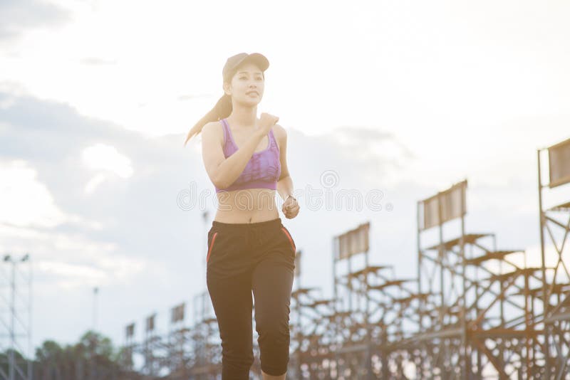 Young Woman Runner is Jogging on the Street Be Running for Exercise ...