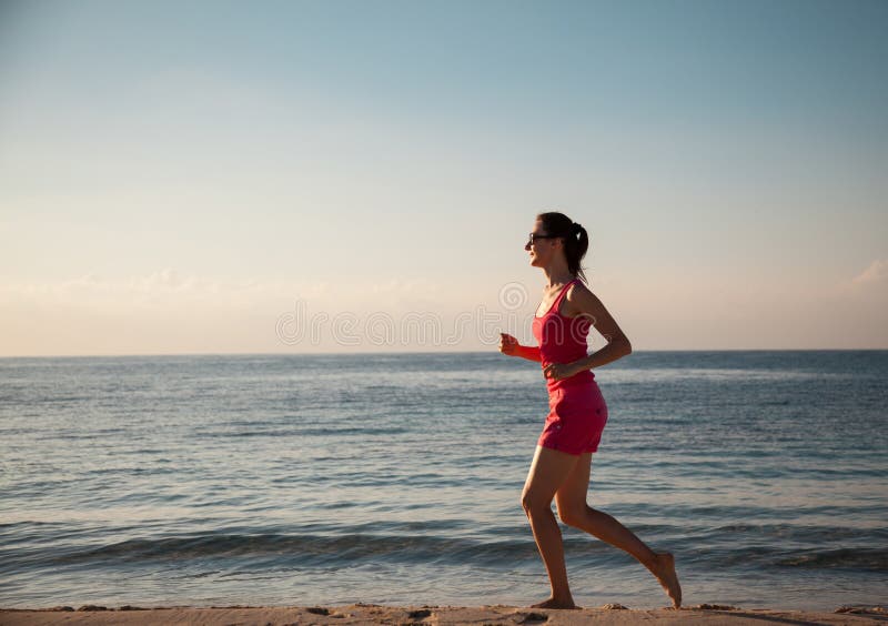 Young Woman Running Along the Coast Stock Photo - Image of dawn ...
