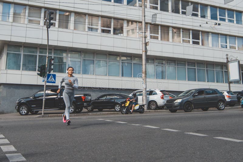 A Young Woman Running Fast on a Crosswalk Stock Image - Image of ...