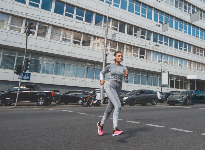 A Young Woman Running Fast at the Intersection Stock Photo - Image of ...