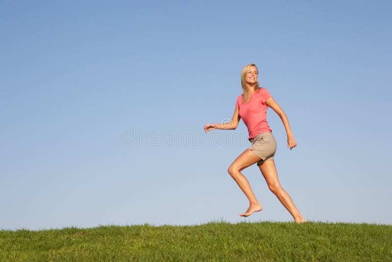 Young Woman Running through Field Stock Image - Image of running, happy ...