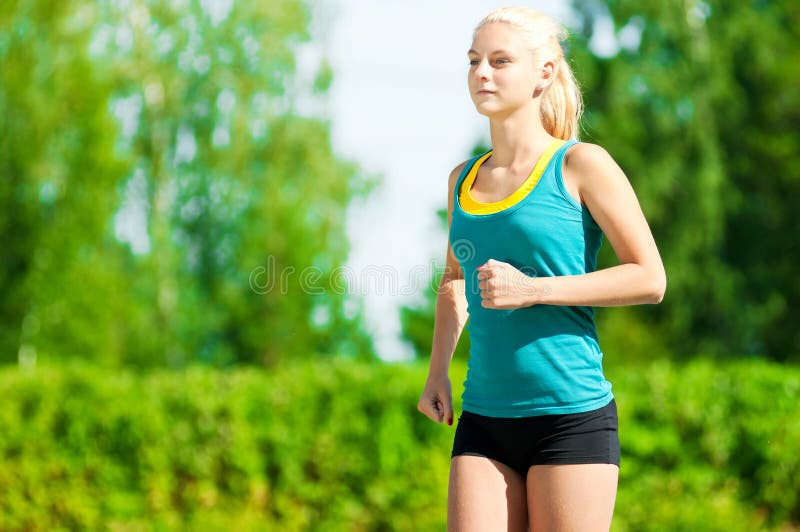Young Woman Running in Green Park Stock Image - Image of concentration ...
