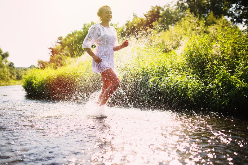 Young Woman Running in Shallow Water Stock Photo - Image of outside ...