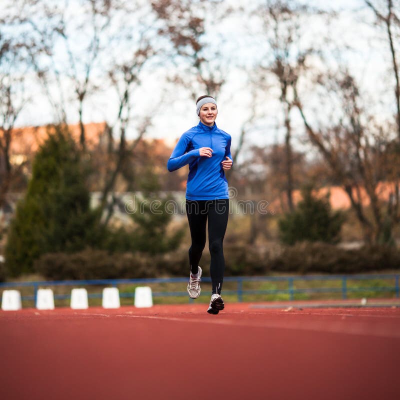 Young Woman Running at a Track Stock Image - Image of energy, cheerful ...