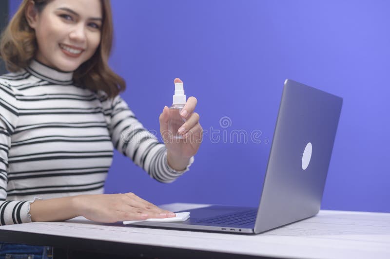 Young Woman Sanitizing Alcohol Spray with Computer , Covid-19 ...