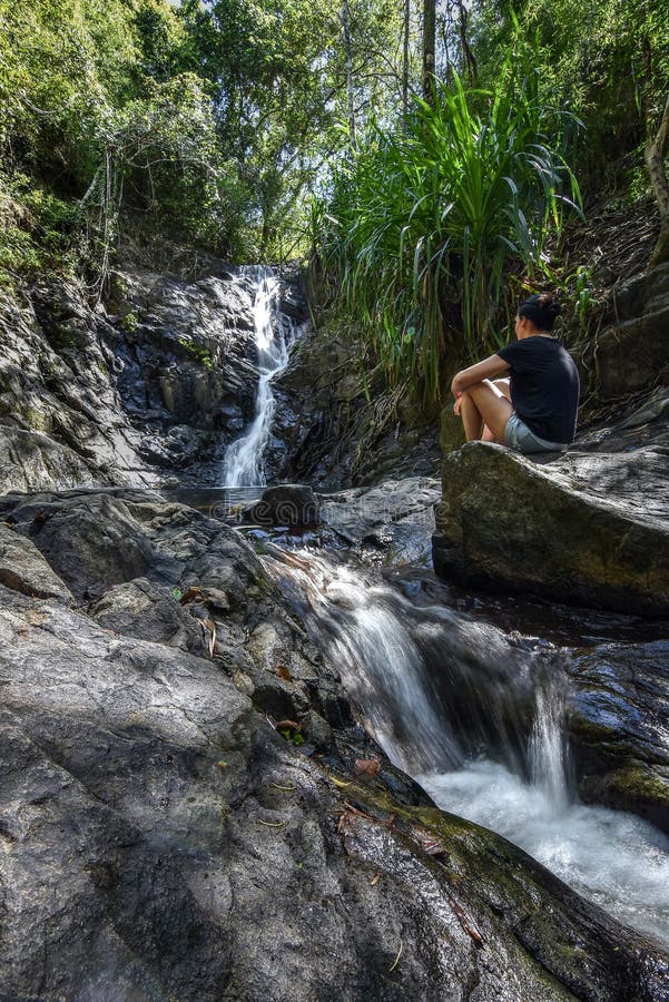 Young Woman Sat on Rocks Looking at a Waterfall Editorial Stock Image ...
