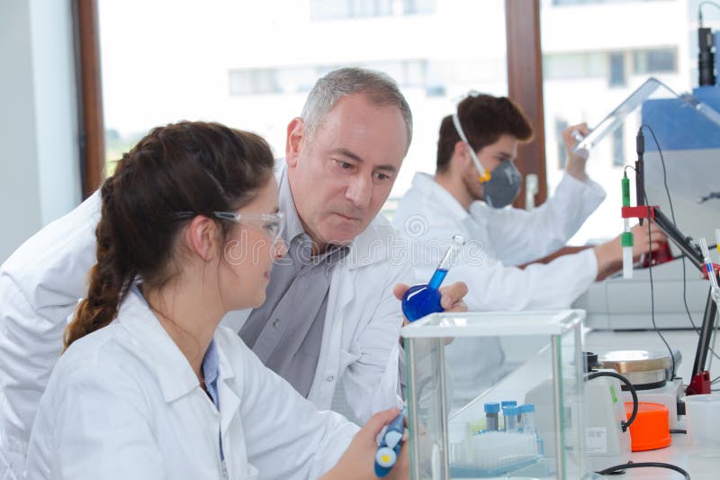 Young Woman in Science Class Stock Image - Image of expertise ...