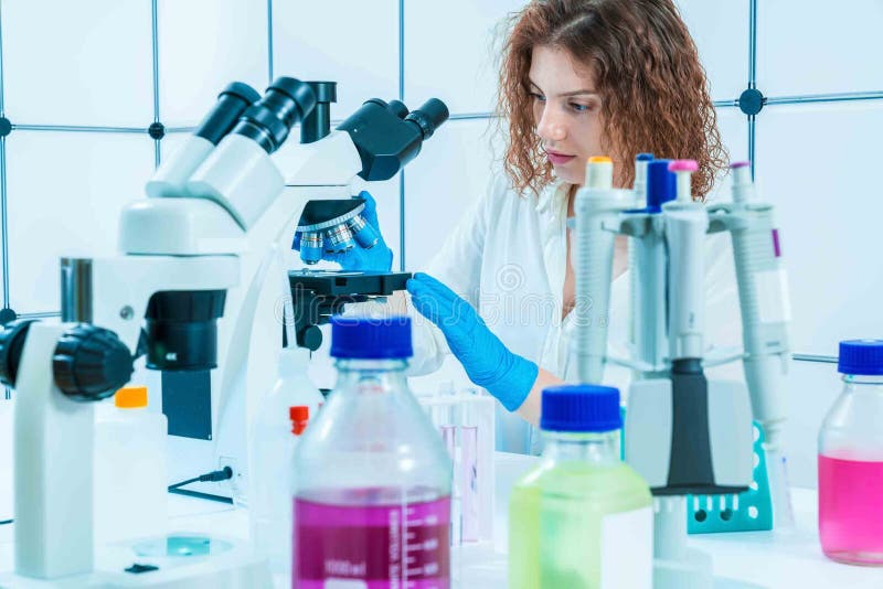 Young Woman in a Scientific Laboratory Working with a Microscope Stock ...