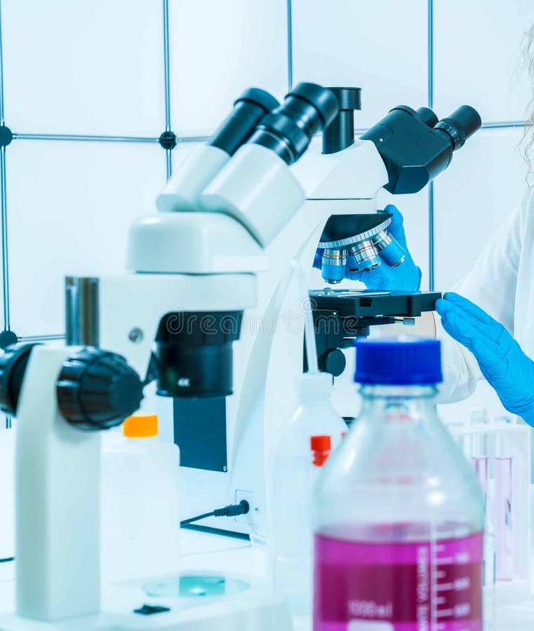 Young Woman in a Scientific Laboratory Working with a Microscope Stock ...