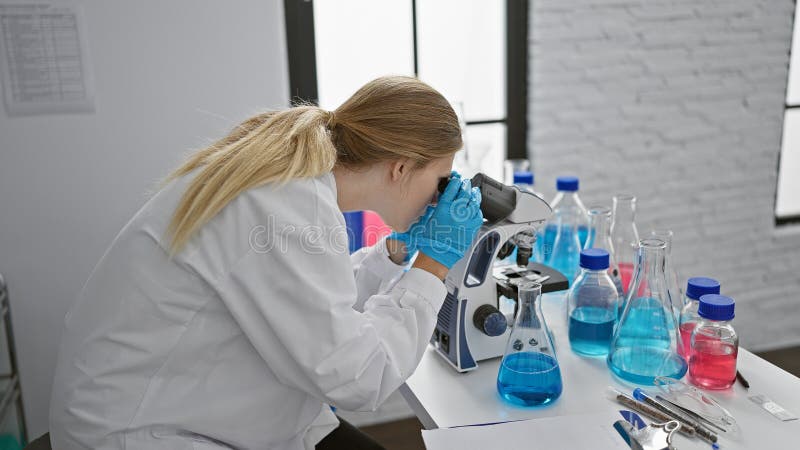Woman Scientist Using Microscope in a Laboratory Setting, Reflecting ...