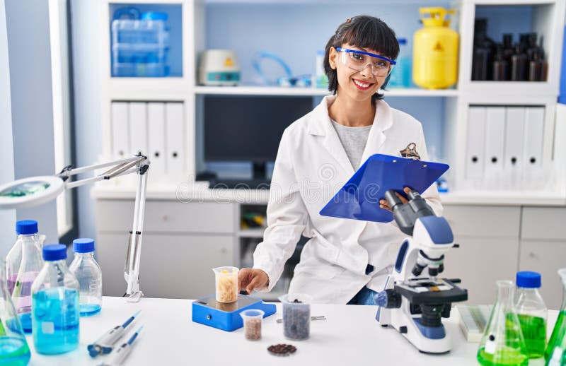 Young Woman Scientist Measuring Liquid at Laboratory Stock Photo ...