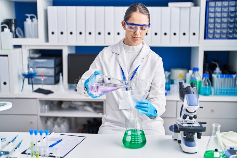 Young Woman Scientist Measuring Liquid at Laboratory Stock Photo ...
