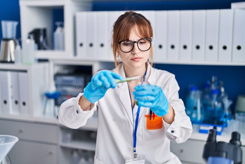 Young Woman Scientist Measuring Liquid at Laboratory Stock Photo ...