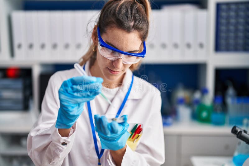 Young Woman Scientist Pouring Liquid on Sample at Laboratory Stock ...