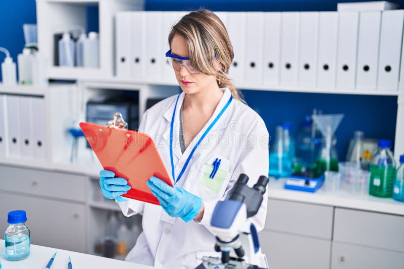 Young Woman Scientist Reading Report at Laboratory Stock Photo - Image ...