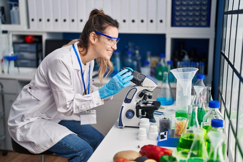 Young Woman Scientist Smiling Confident Using Microscope at Laboratory ...