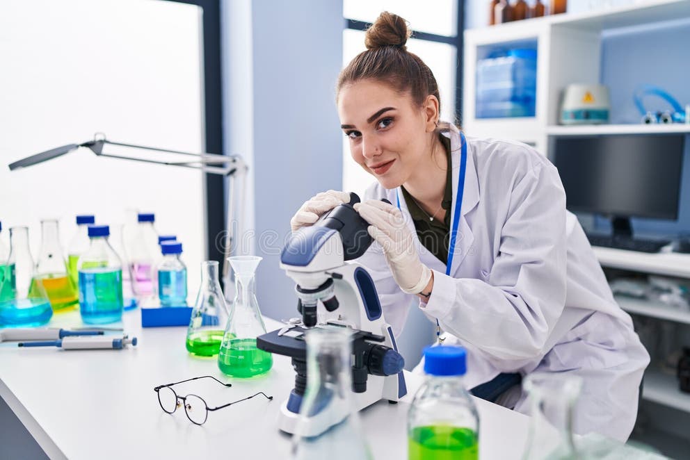 Young Woman Scientist Using Microscope at Laboratory Stock Photo ...