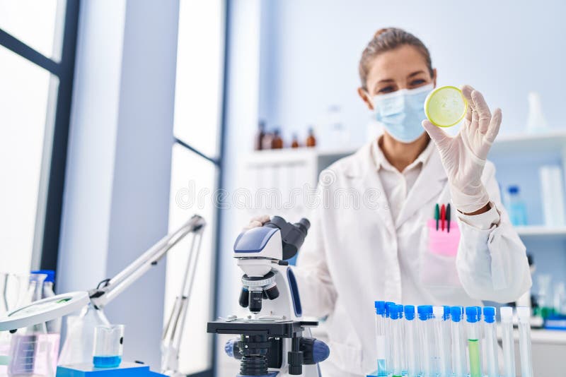 Young Woman Scientist Using Microscope Working at Laboratory Stock ...