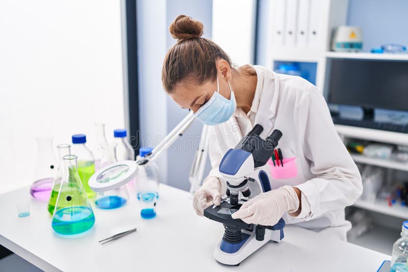 Young Woman Scientist Using Microscope Working at Laboratory Stock ...