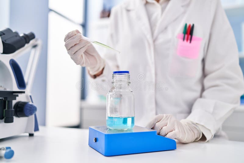 Young Woman Scientist Weighing Liquid at Laboratory Stock Photo - Image ...