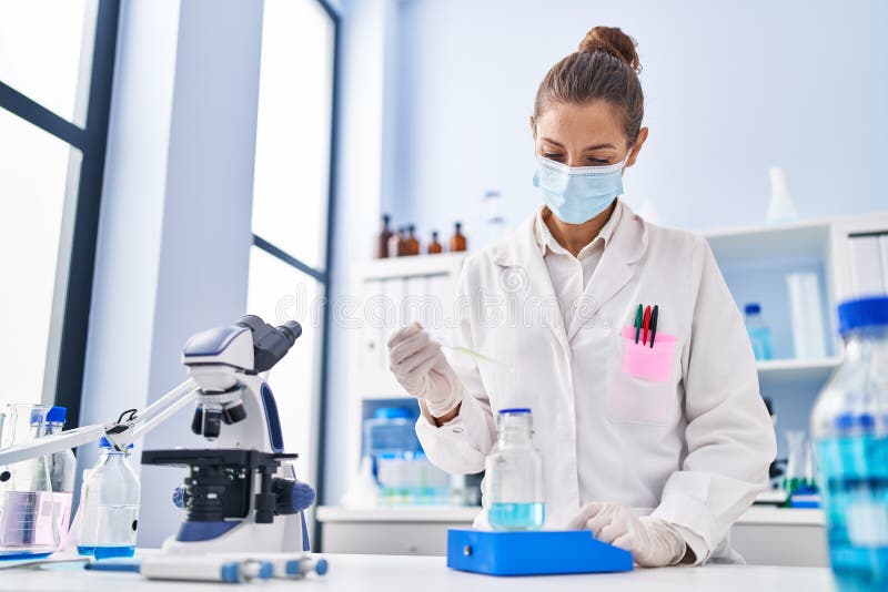 Young Woman Scientist Weighing Liquid at Laboratory Stock Image - Image ...