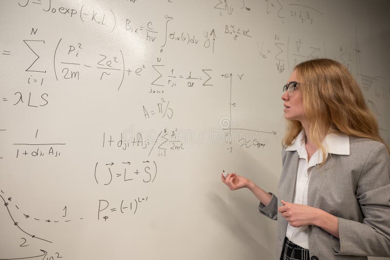 Young Woman Scientist Writes Formulas on a White Board. Stock Photo ...