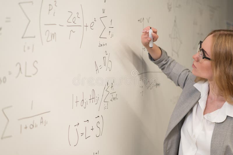 Young Woman Scientist Writes Formulas on a White Board. Stock Image ...