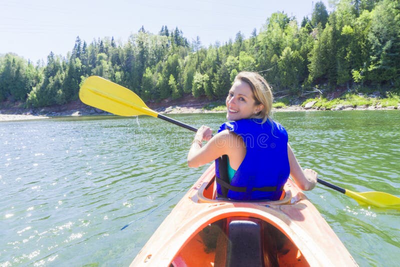 Young woman sea kayaking stock image. Image of person - 99075555