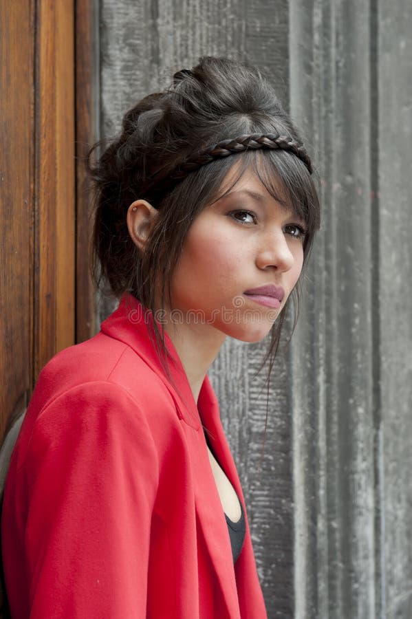 Young Woman Seated Against a Door Stock Photo - Image of female, person ...