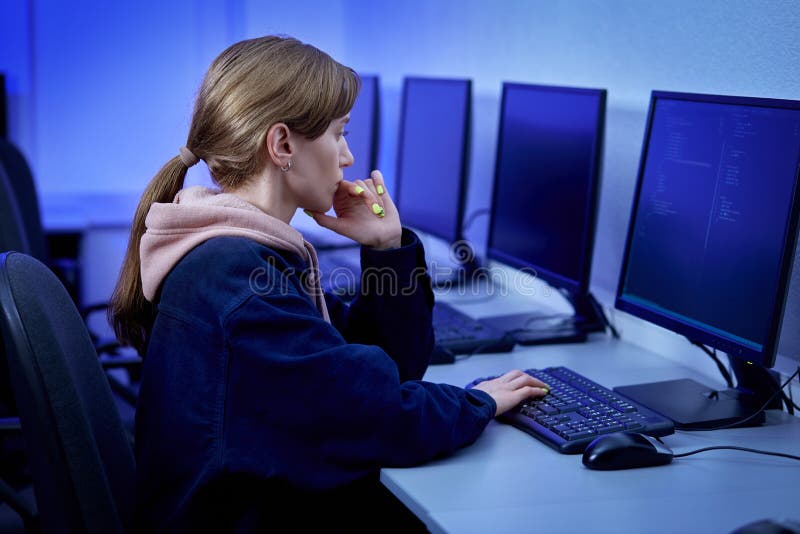 A Young Woman with a Serious Face Works As an Online Programmer in an ...