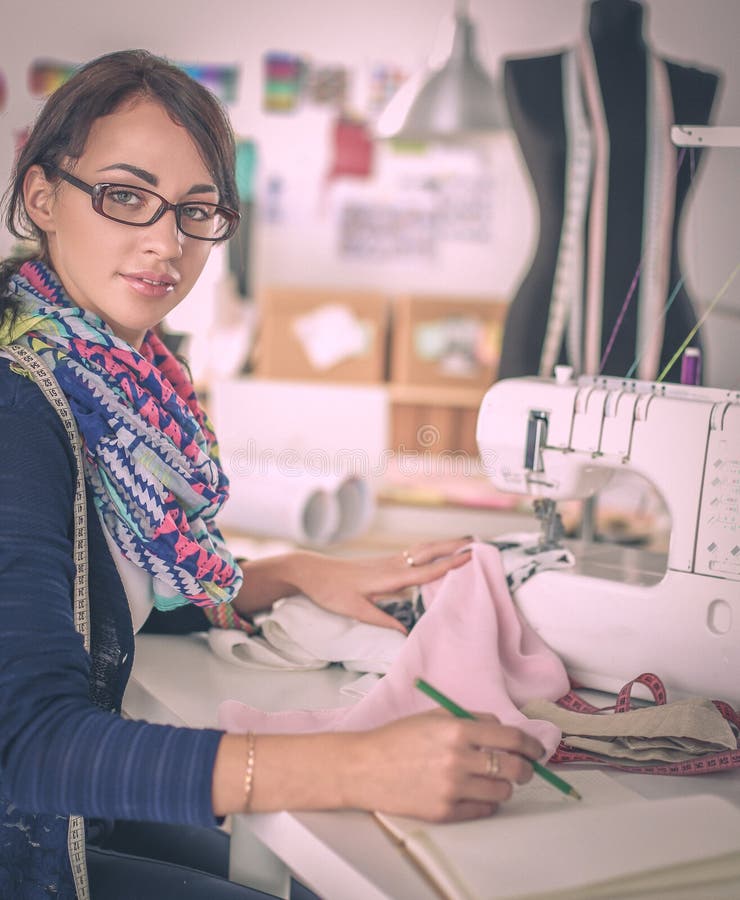 Young Woman Sewing while Sitting at Her Working Place Stock Image ...
