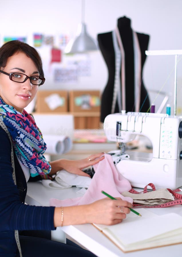 Young Woman Sewing while Sitting at Her Working Stock Photo - Image of ...
