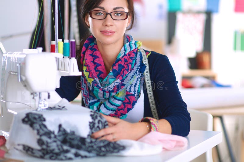 Young Woman Sewing while Sitting at Her Working Stock Image - Image of ...