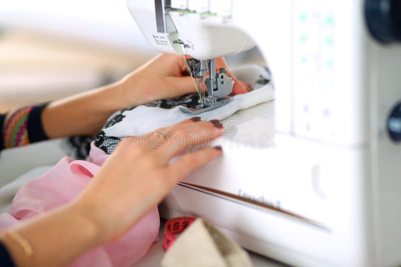 Young Woman Sewing while Sitting at Her Working Stock Photo - Image of ...