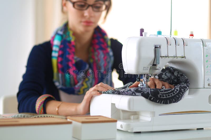 Young Woman Sewing while Sitting at Her Working Place Stock Photo ...