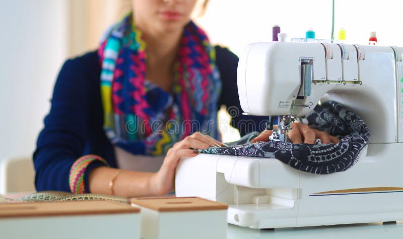 Young Woman Sewing while Sitting at Her Working Place Stock Photo ...