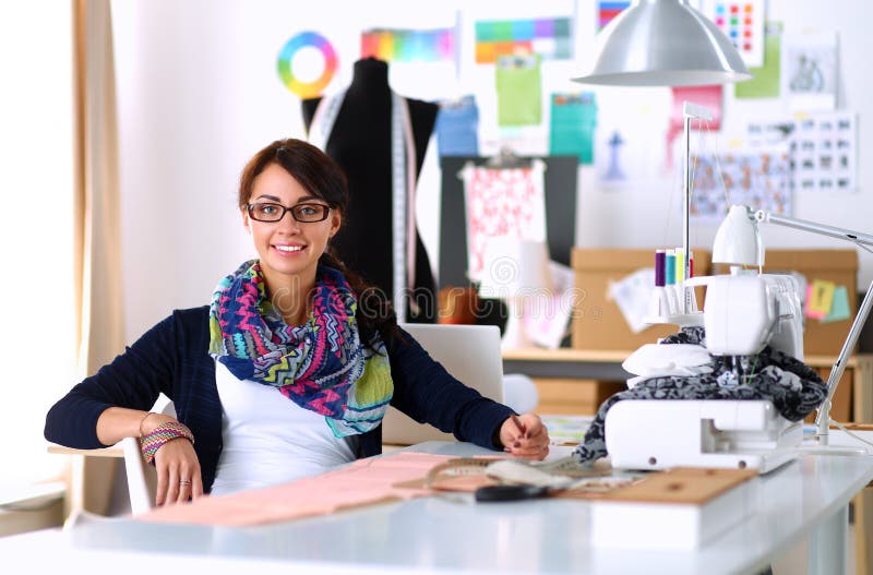 Young Woman Sewing while Sitting at Her Working Place Stock Photo ...
