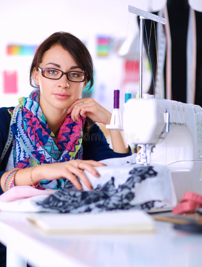 Young Woman Sewing while Sitting at Her Working Place Stock Photo ...