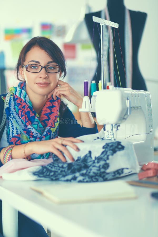 Young Woman Sewing while Sitting at Her Working Place Stock Image ...