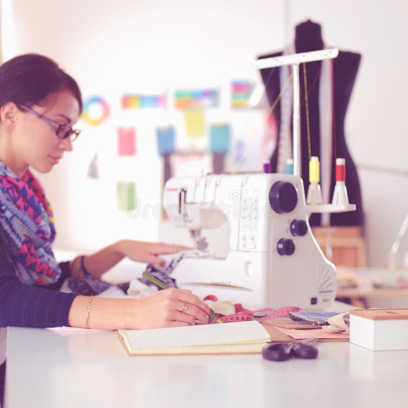 Young Woman Sewing while Sitting at Her Working Place Stock Image ...