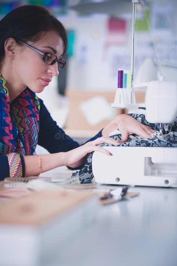 Young Woman Sewing while Sitting at Her Working Place . Stock Photo ...