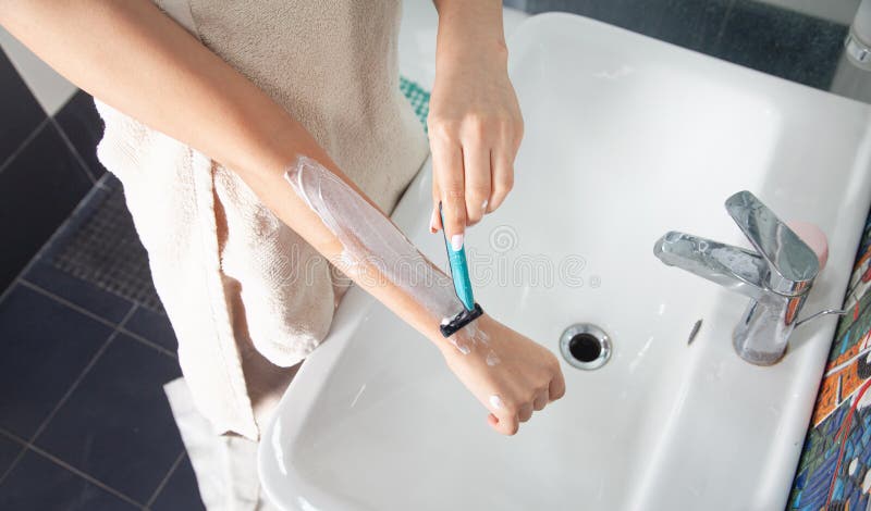 Young Woman Shaving Her Hand at Bathroom Stock Photo - Image of female ...