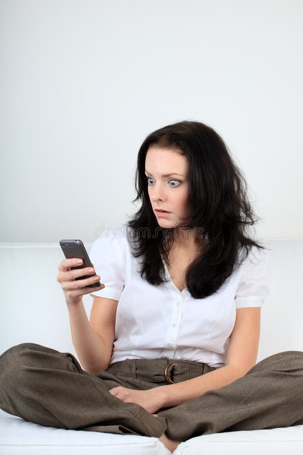Young Woman Shocked by Text Message on Her Cell Phone Stock Photo ...