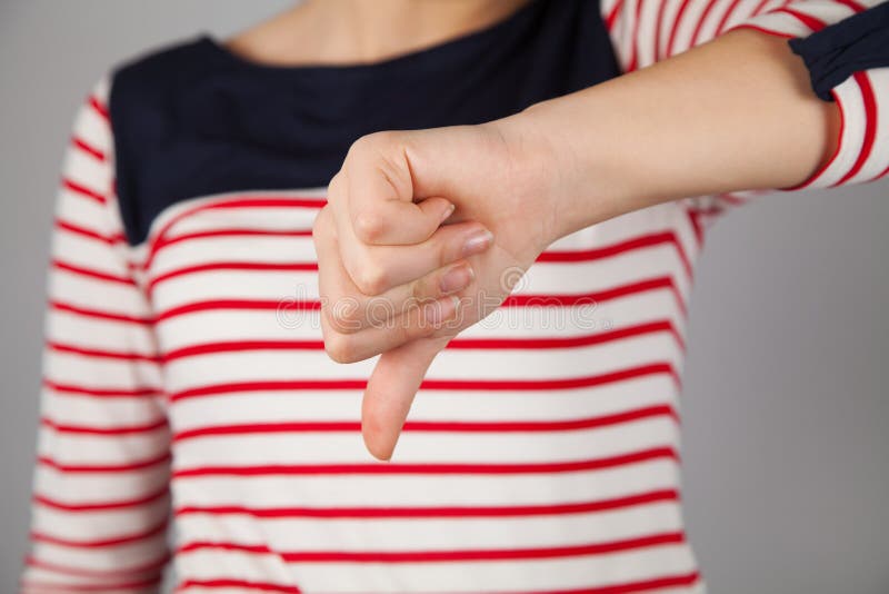 Young Woman Shows a Sign of a Thumb Down. Negative Gesture Stock Photo ...