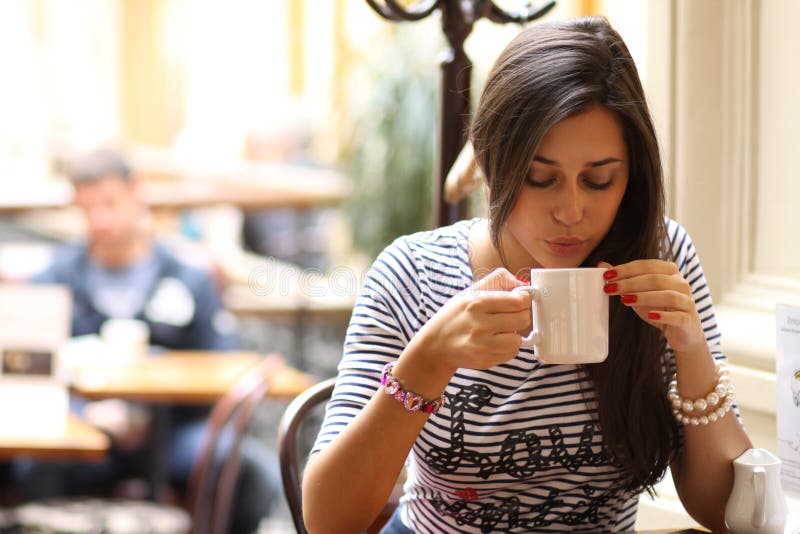 Young woman sipping coffee stock photo. Image of gerl - 14799580